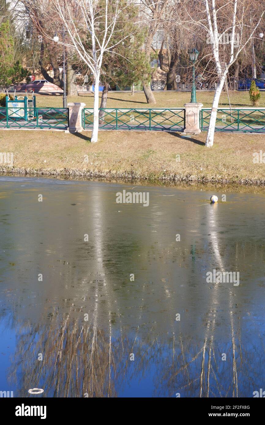 Ball Floating on Frozen River at park Stock Photo - Alamy