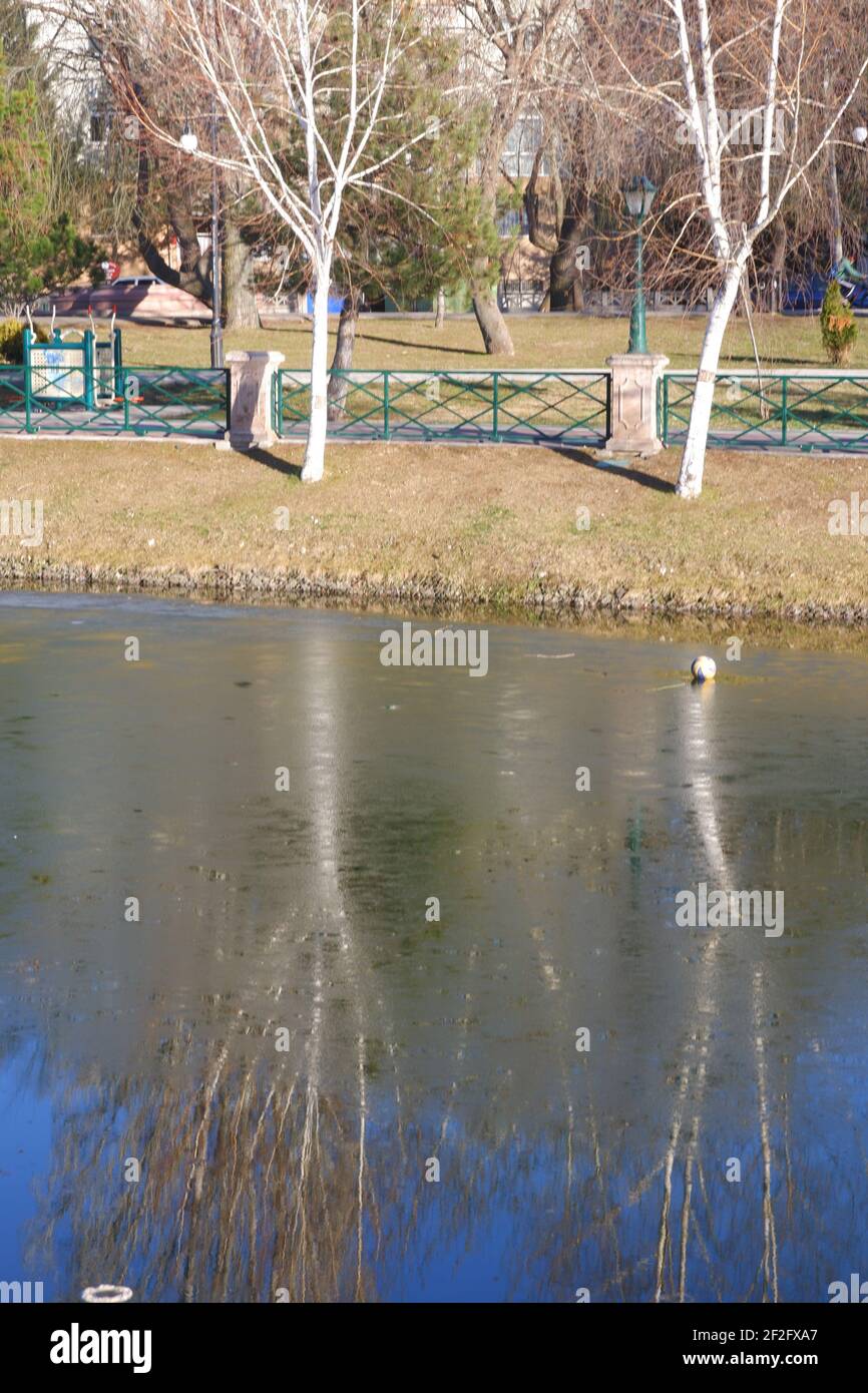 Ball Floating on Frozen River at park Stock Photo - Alamy