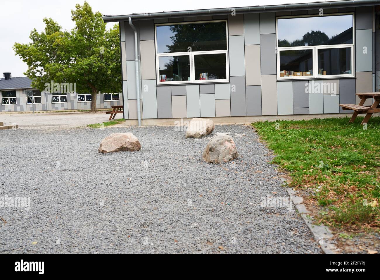 A school backyard with rocks and grass Stock Photo - Alamy