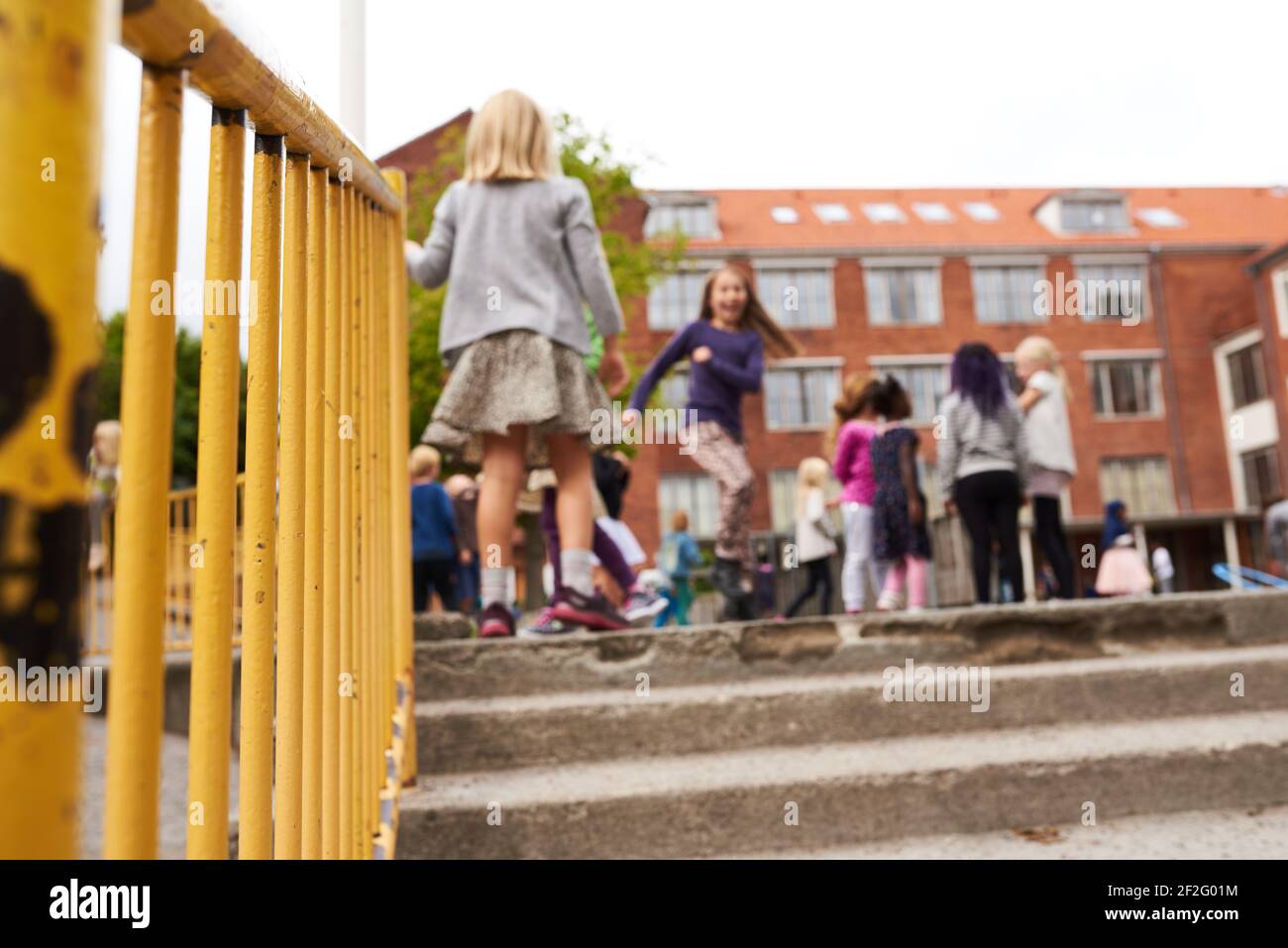 Young kids playing on the playground at school Stock Photo - Alamy