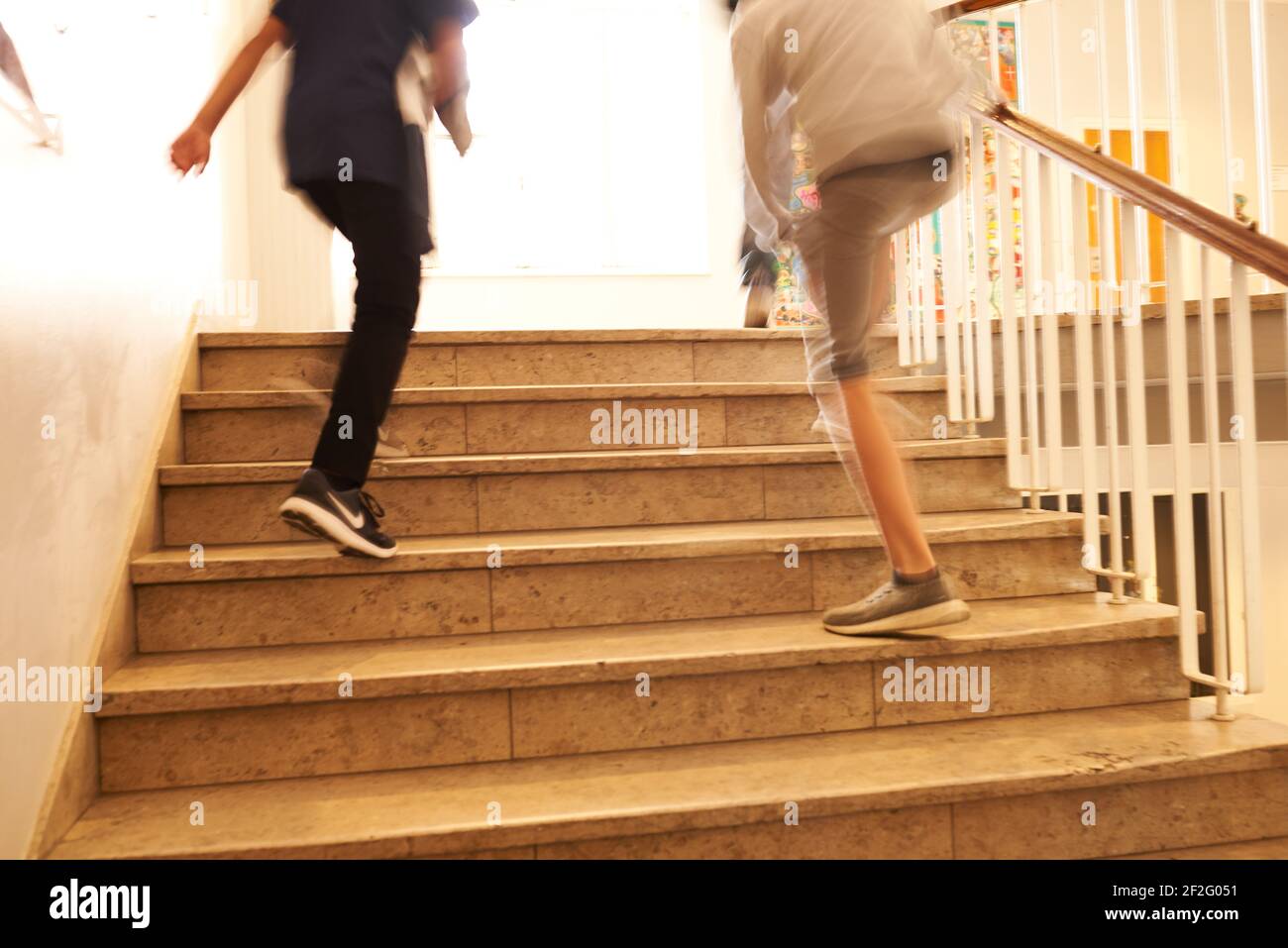 Two students walking up the stairs Stock Photo - Alamy
