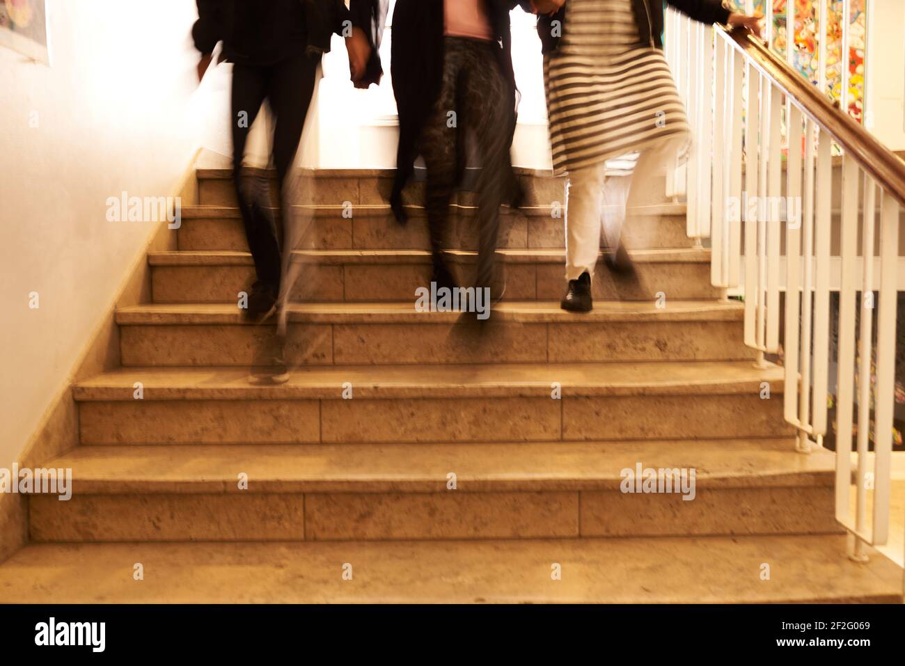 three students walking down the stairs Stock Photo - Alamy