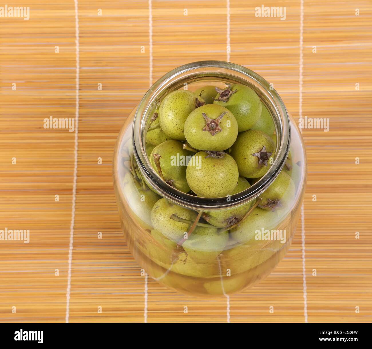 natural small green pears in a glass jar Stock Photo - Alamy