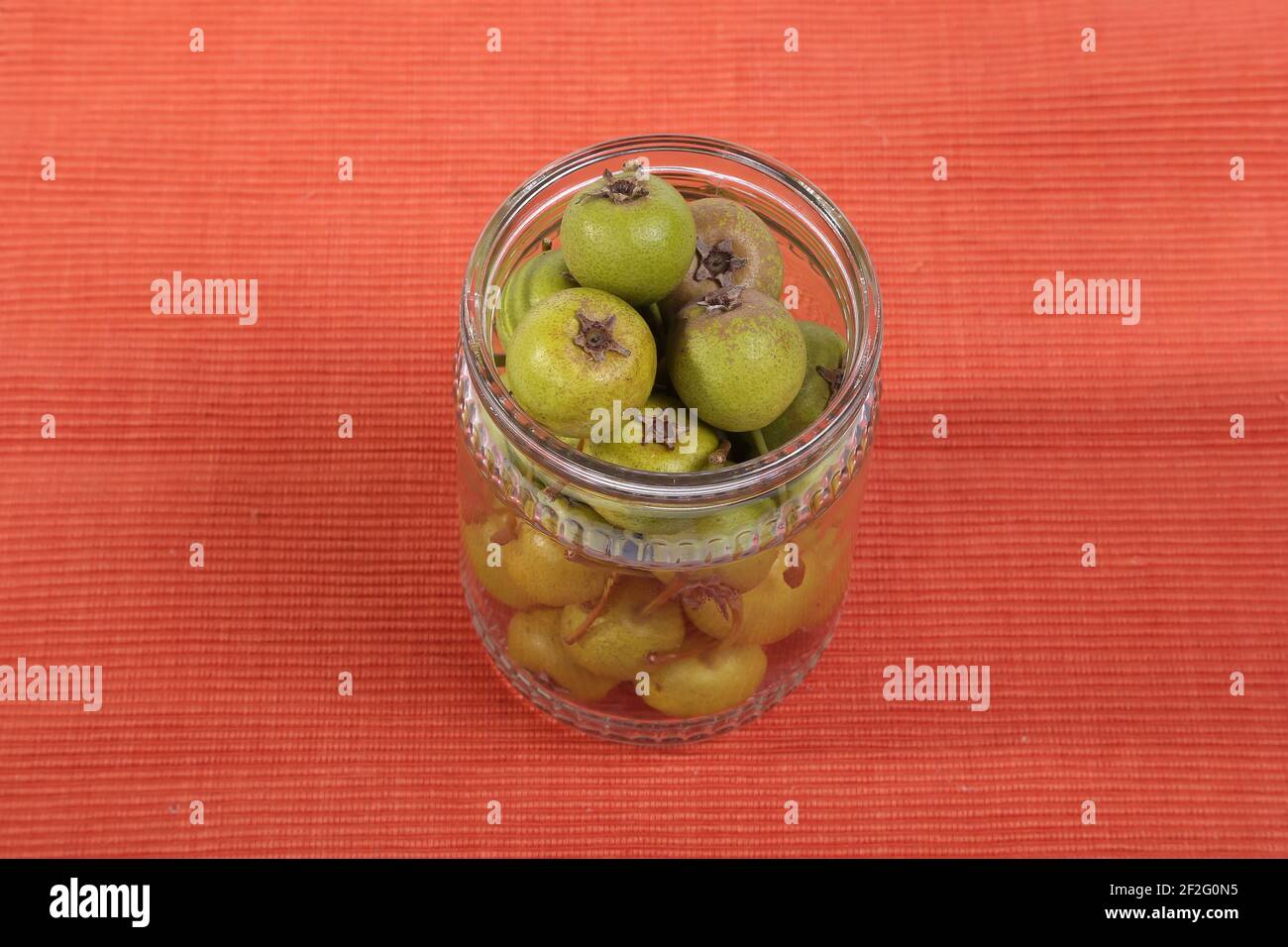 natural small green pears in a glass jar Stock Photo - Alamy