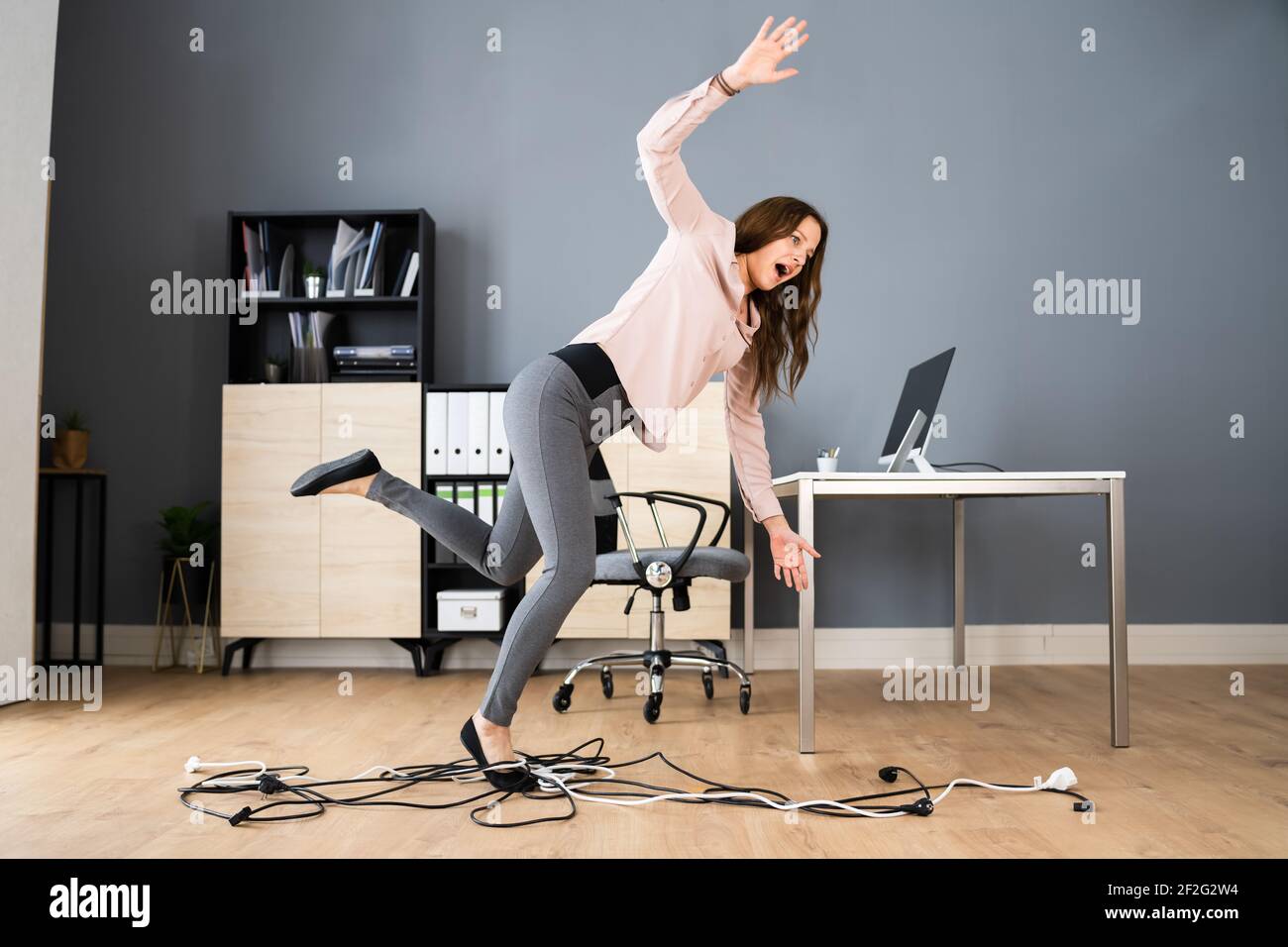 Stumble And Fall Over Wire In Office Stock Photo - Alamy