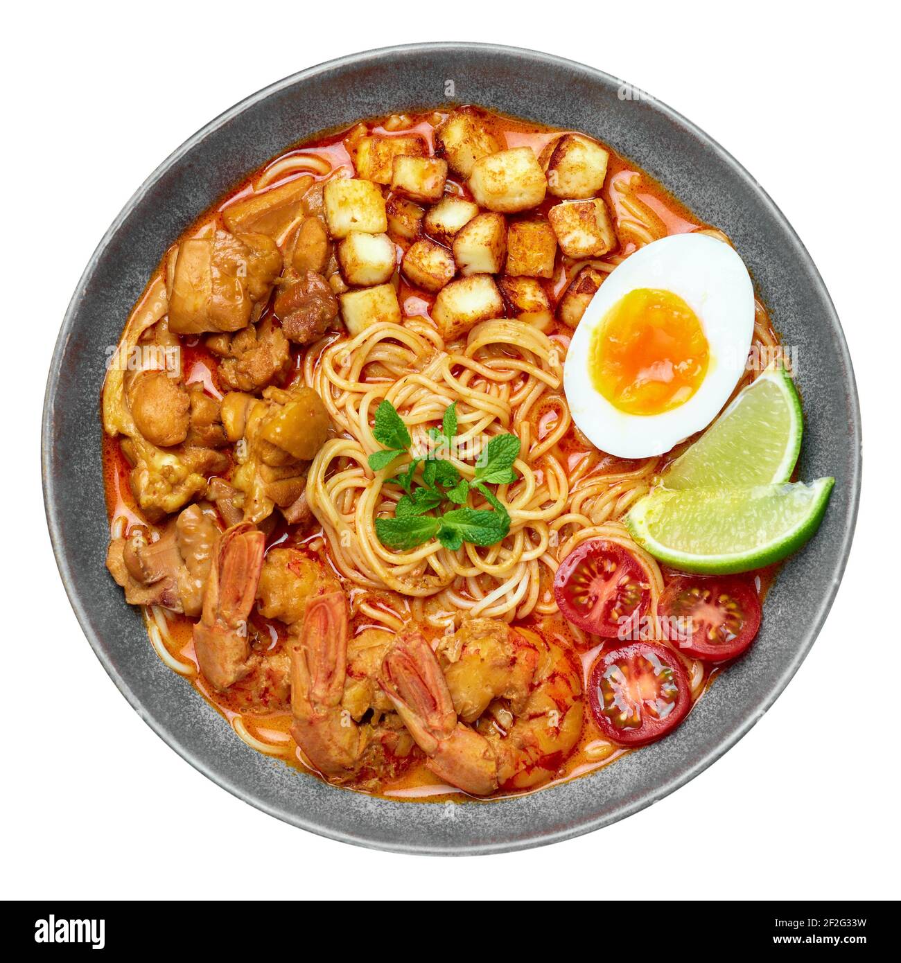 Laksa in gray bowl isolated on white. Coconut noodle soup with chicken ...