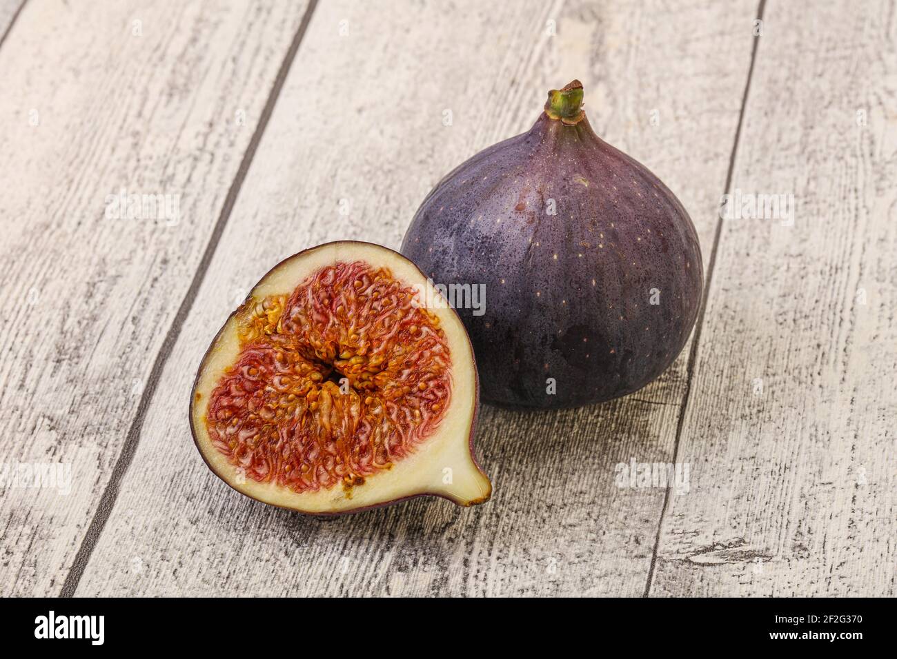 Sweet purple slice of fig fruit Stock Photo - Alamy