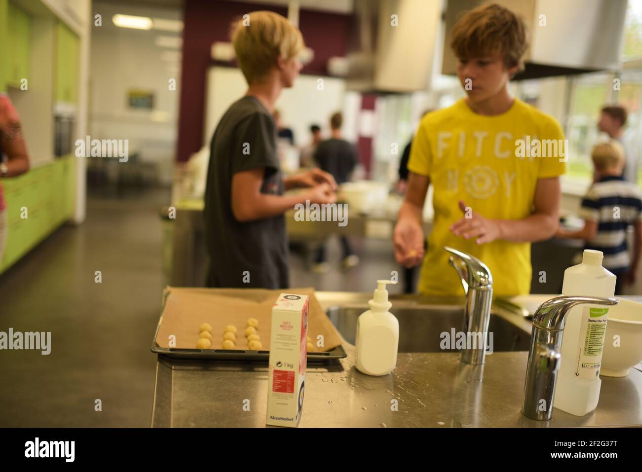 Kids baking cookies in school home ed class Stock Photo - Alamy