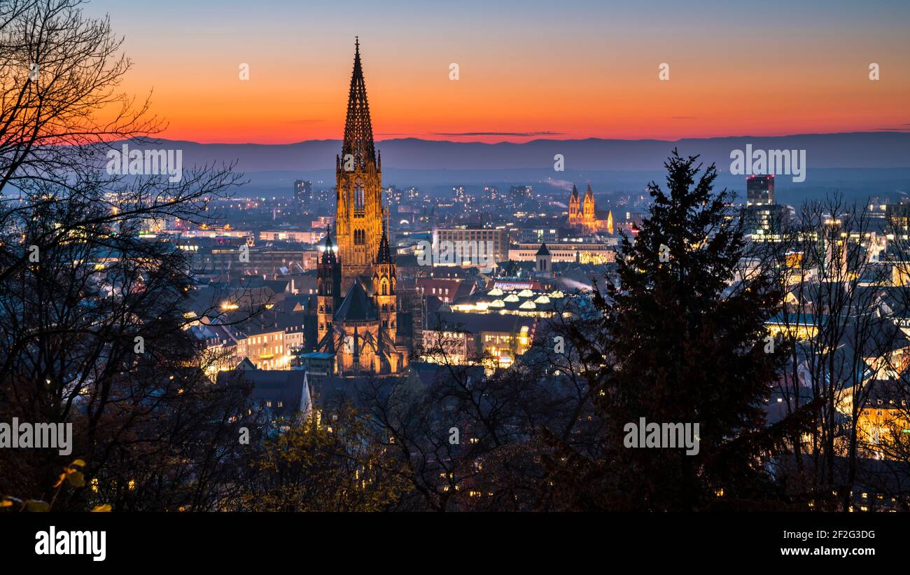 Germany, Freiburg im Breisgau, Magical red sunset sky above skyline of ...