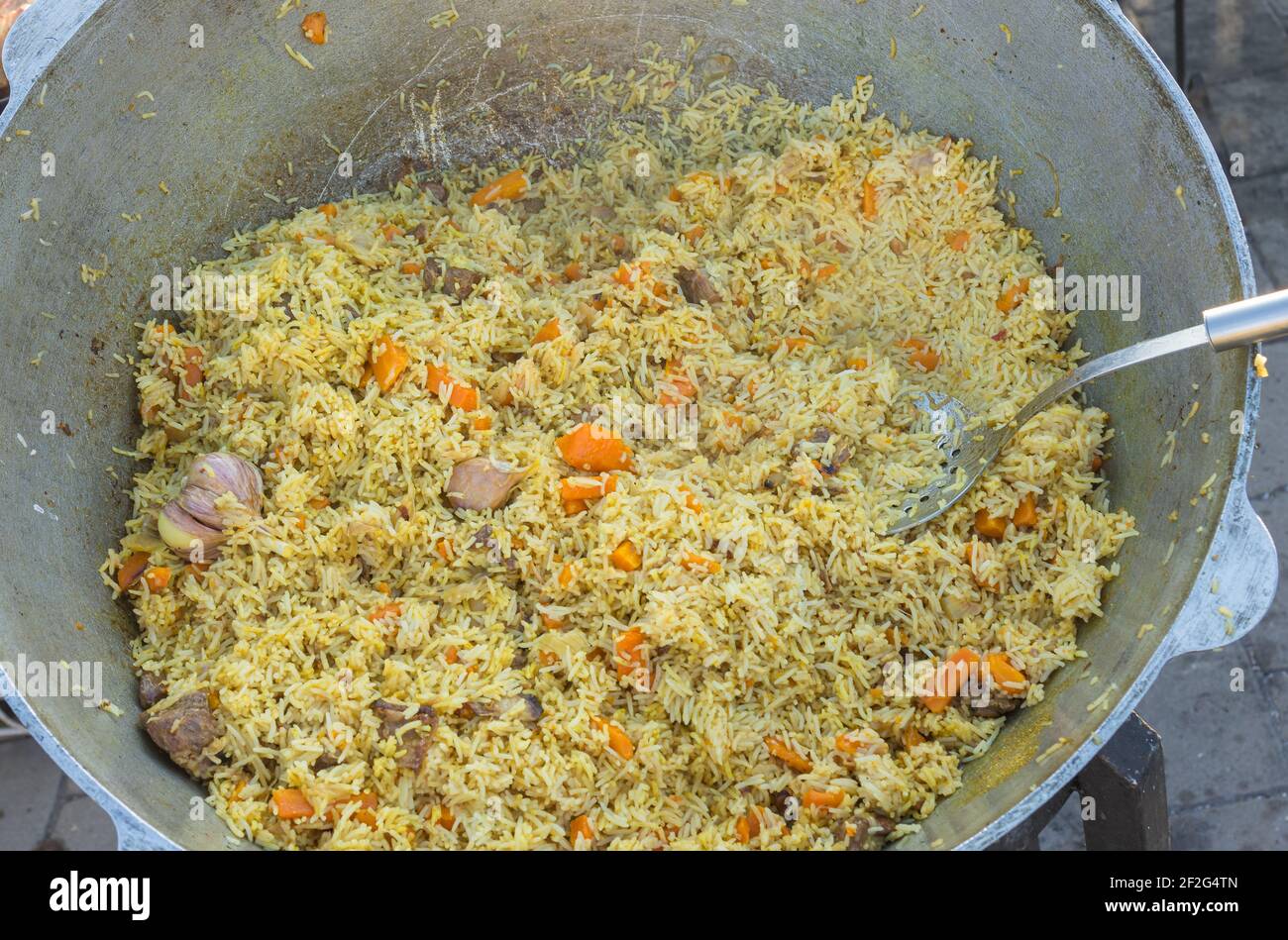 top view on big cauldron with Classic street food pilaf in Ukraine ...