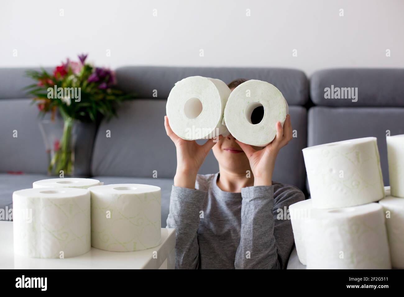 Child, playing with toilet paper ato home Stock Photo - Alamy