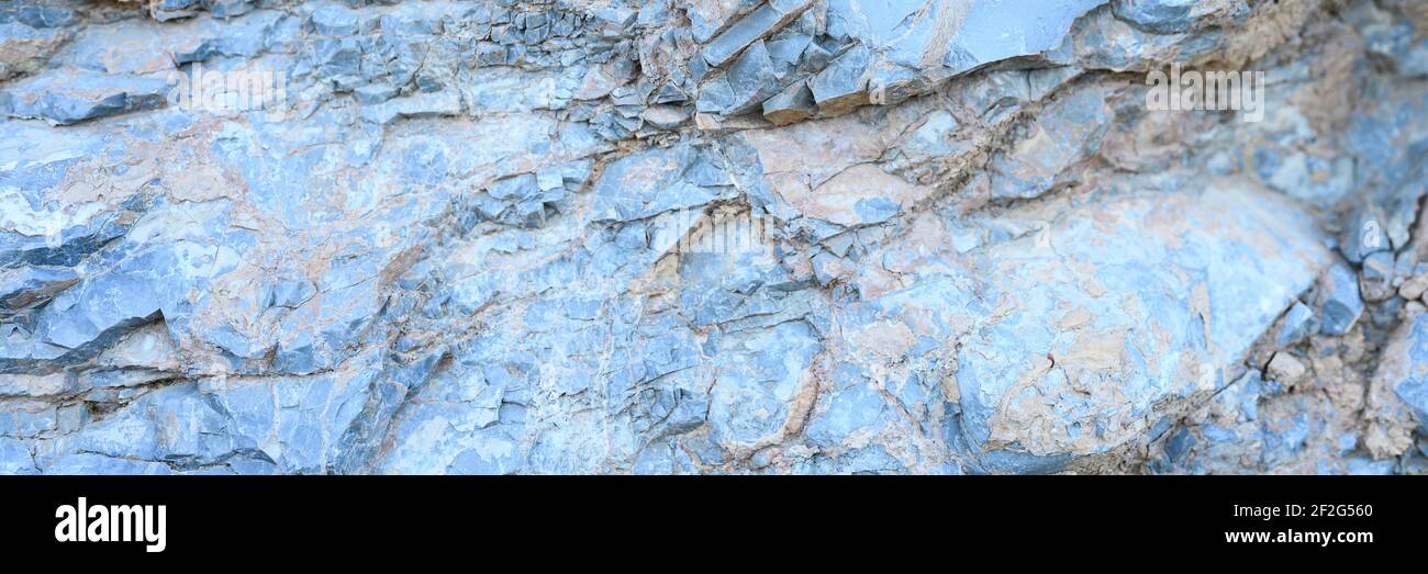 the texture of the surface of the gray blue natural stone rocks as a ...