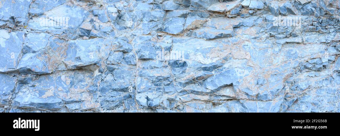 the texture of the surface of the gray blue natural stone rocks as a ...
