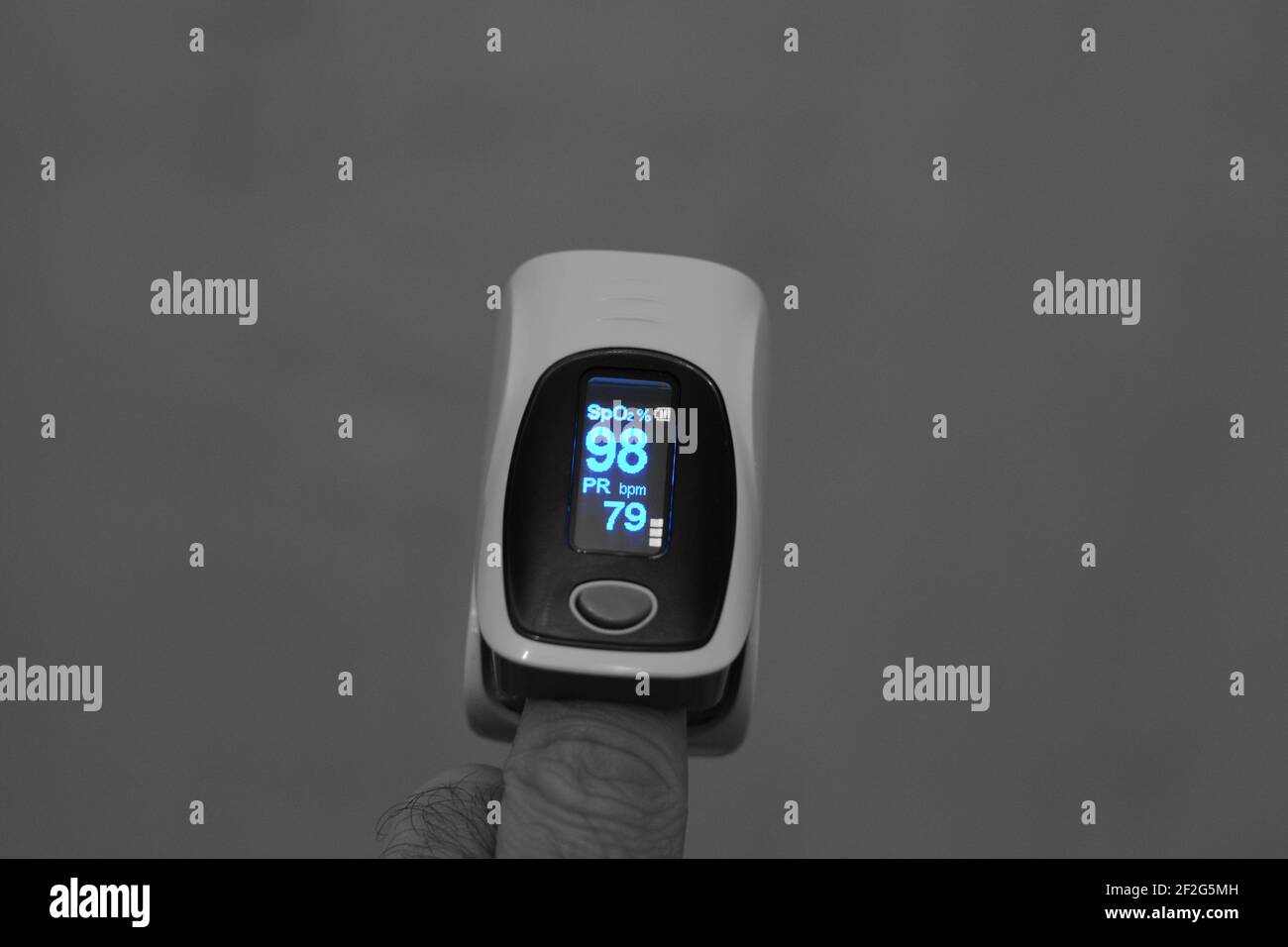 fingertip pulse oximeter equipment connected to the index finger of a ...