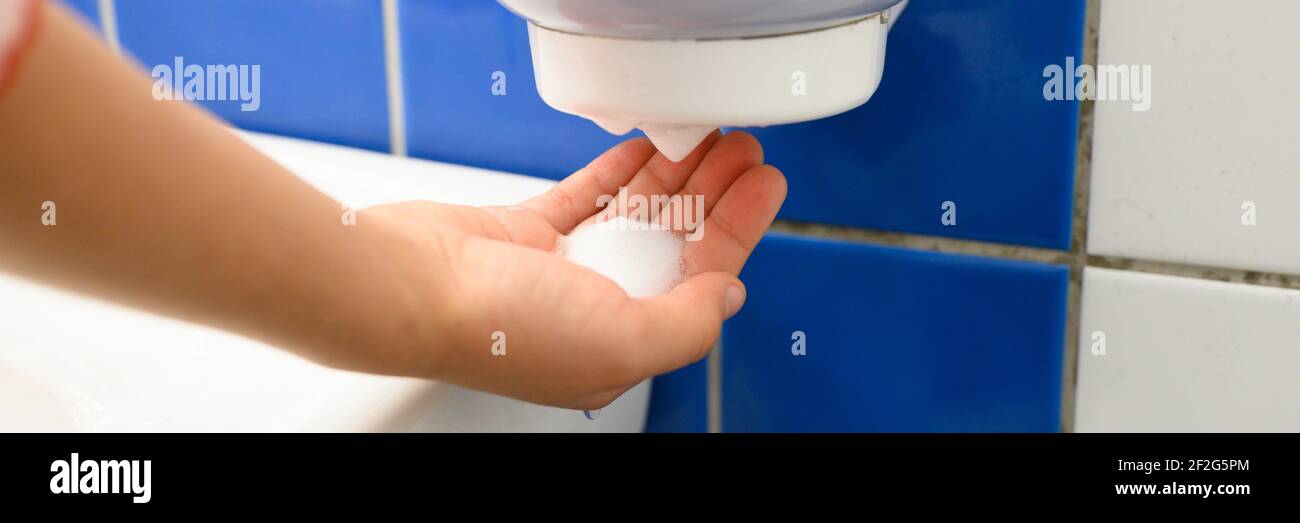 close up of child hand using soap dispenser in washroom. banner Stock ...