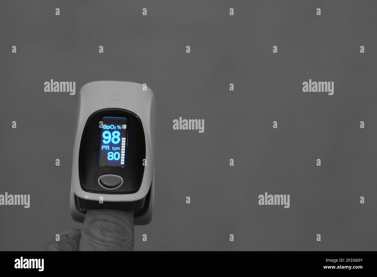 fingertip pulse oximeter equipment connected to the index finger of a ...