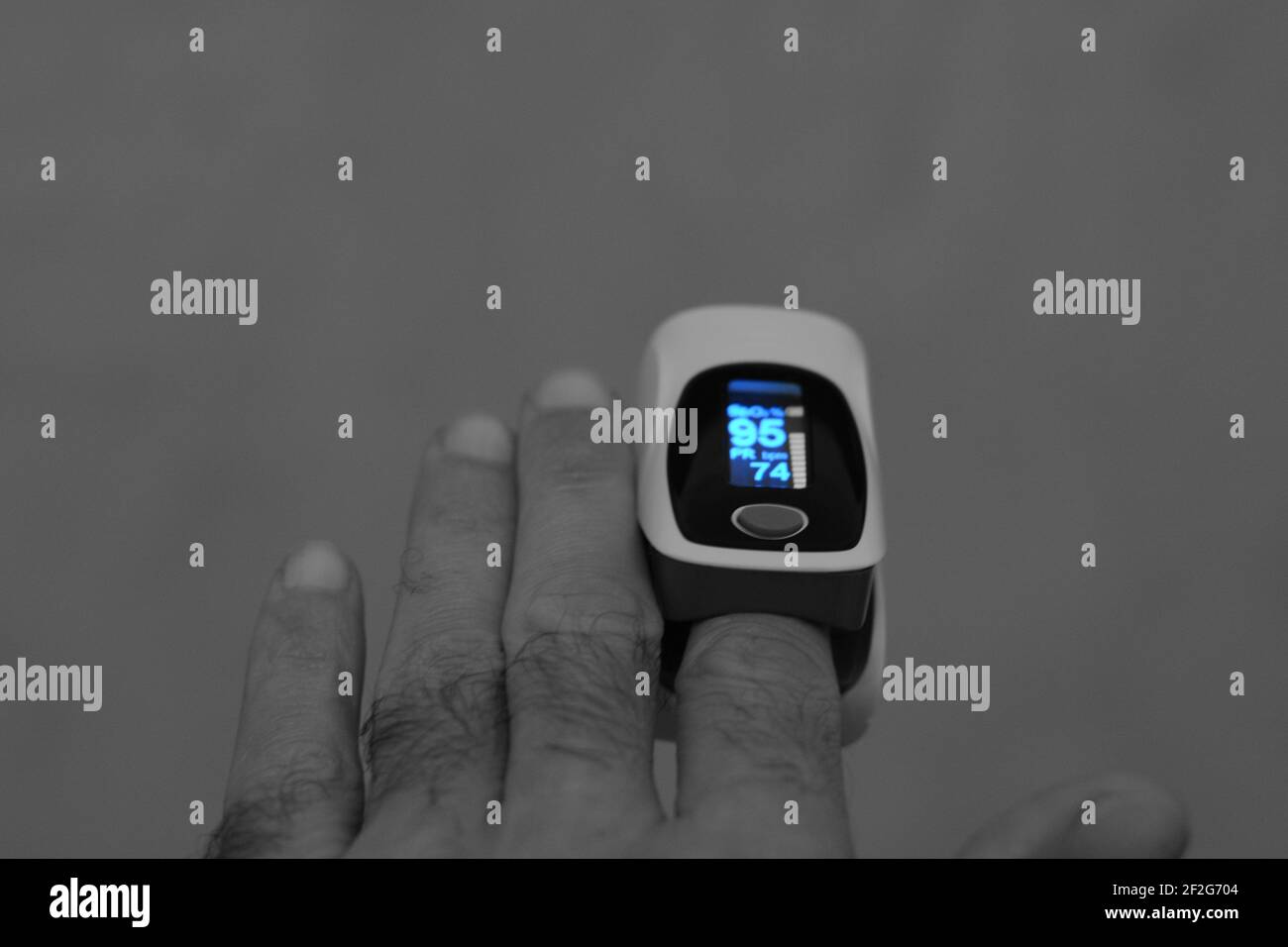 fingertip pulse oximeter equipment connected to the index finger of a ...