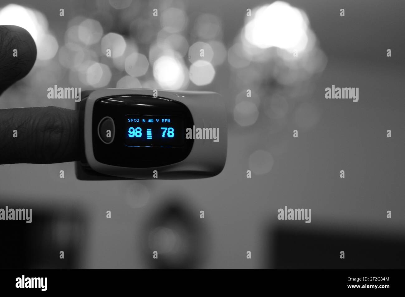 fingertip pulse oximeter equipment connected to the index finger of a ...