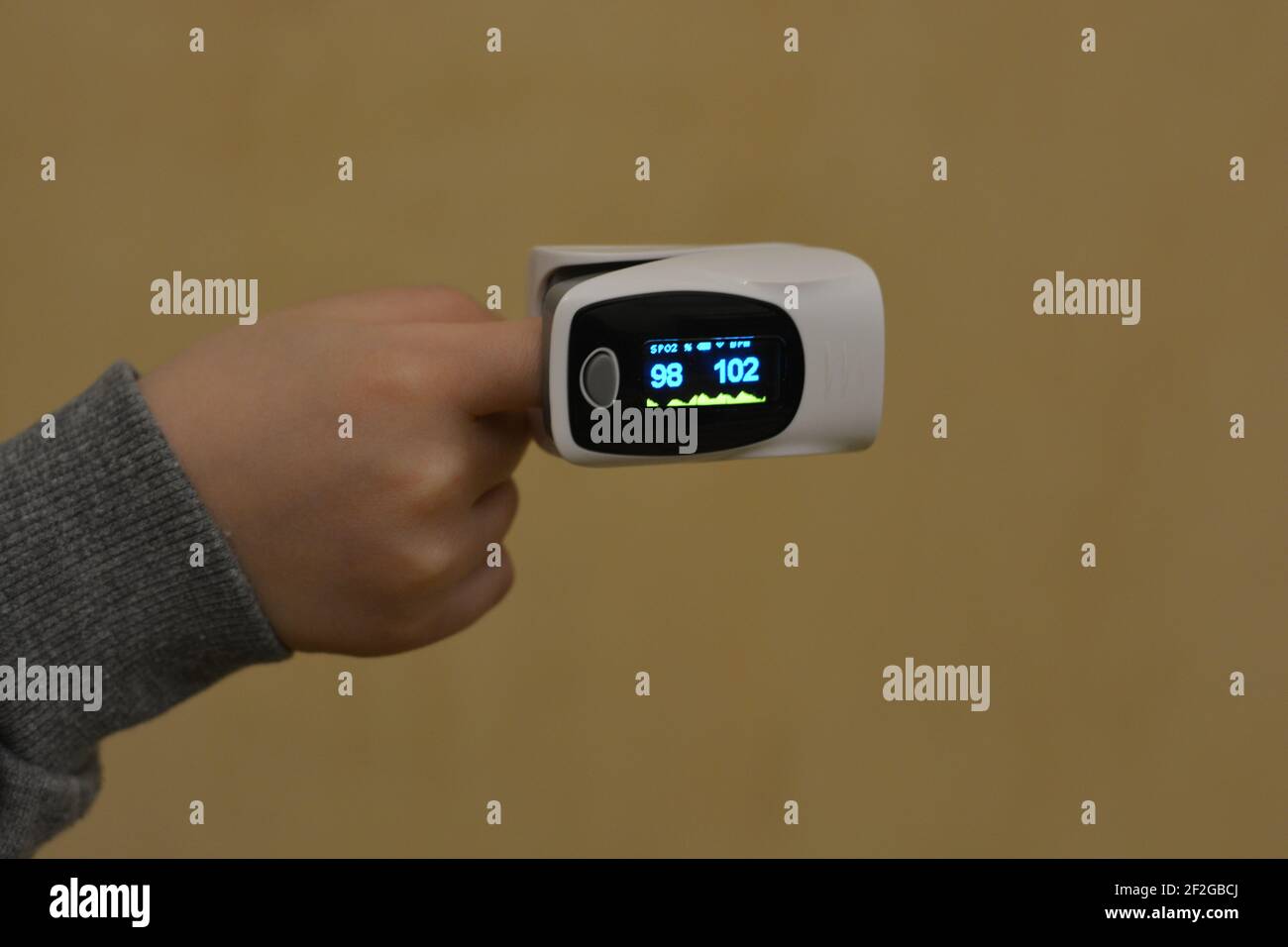 fingertip pulse oximeter equipment connected to the index finger of a ...