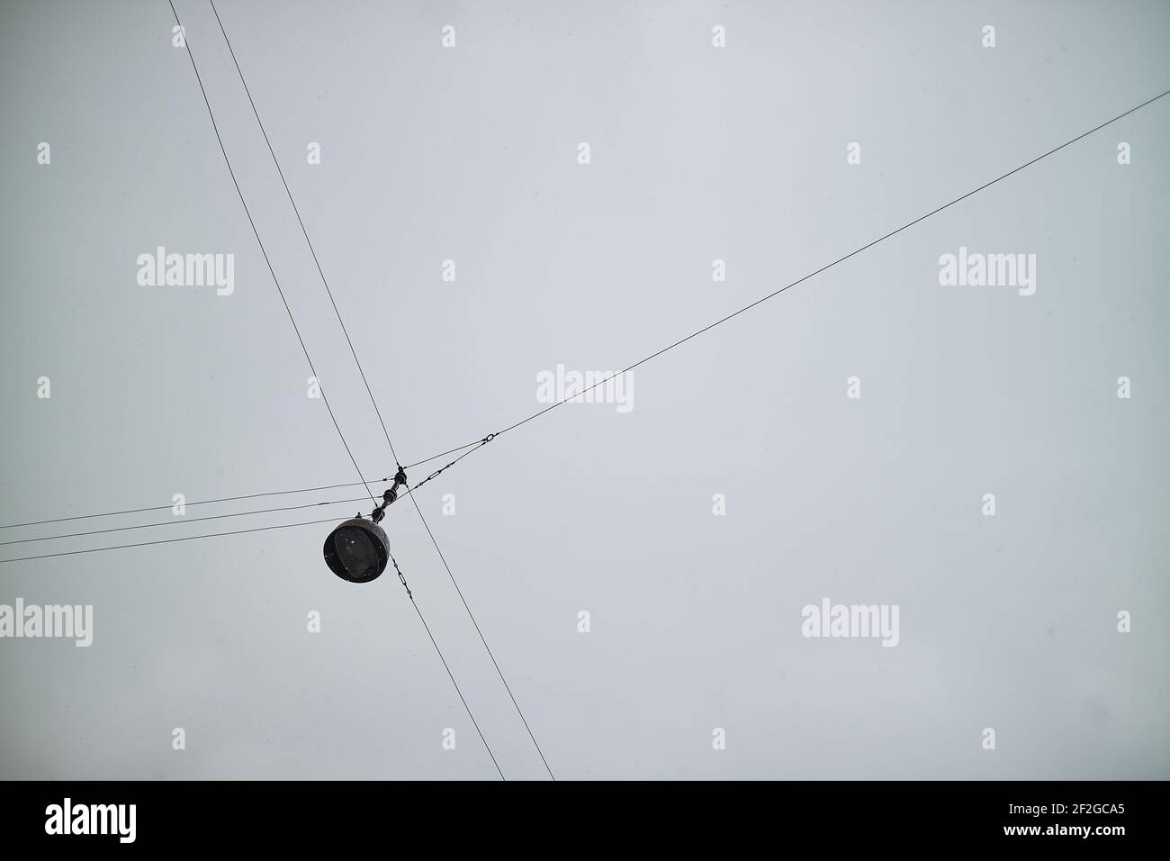 A light poll hanging by electric wires Stock Photo - Alamy