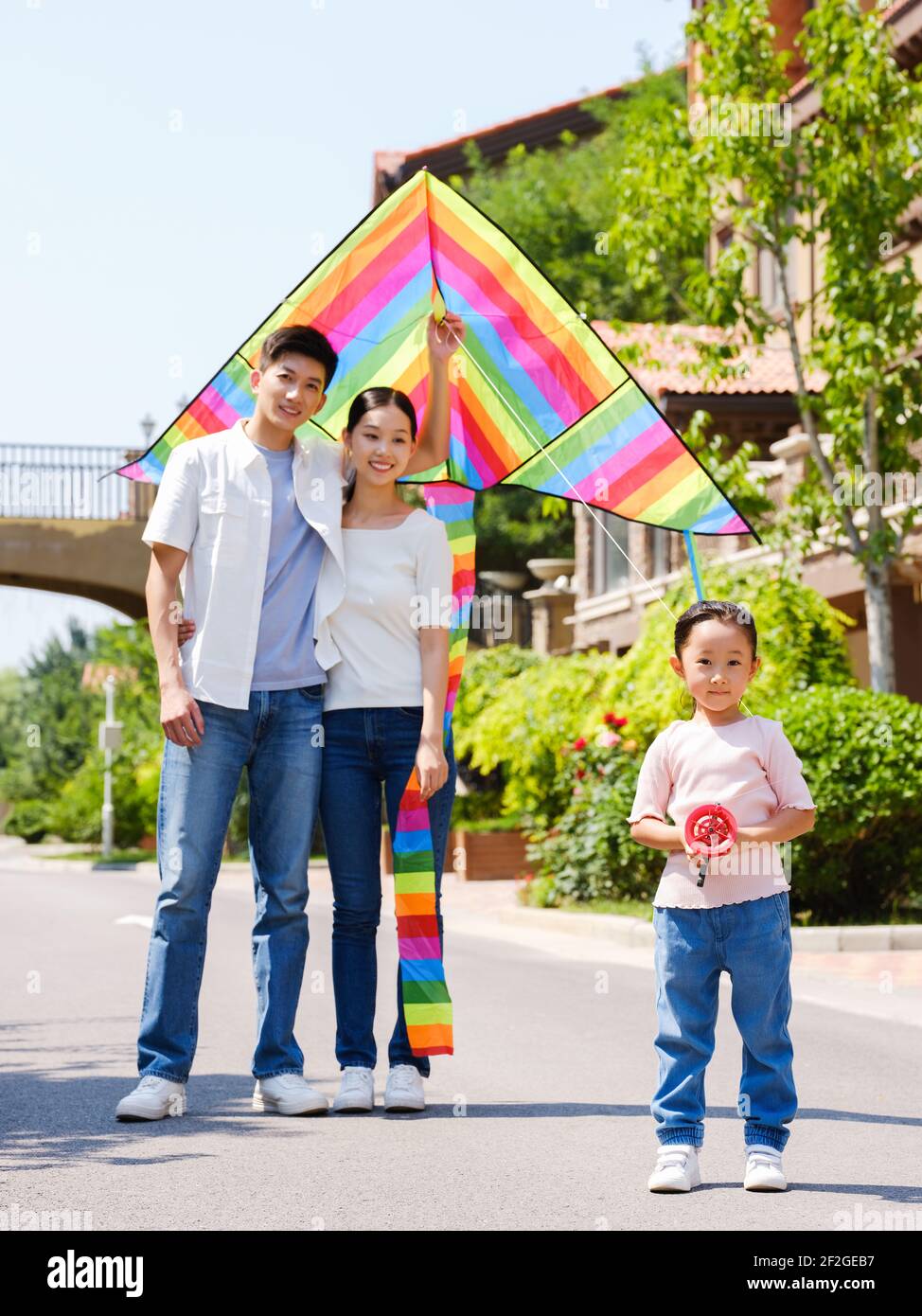 Happy family of three flying kites outdoor looking at the camera Stock ...