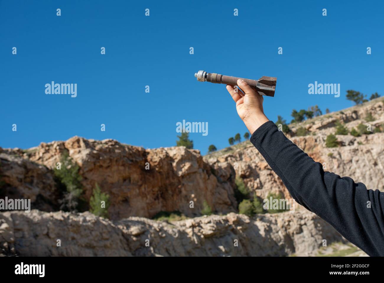 Mortar weapon bomb in man hands on nature background Stock Photo - Alamy