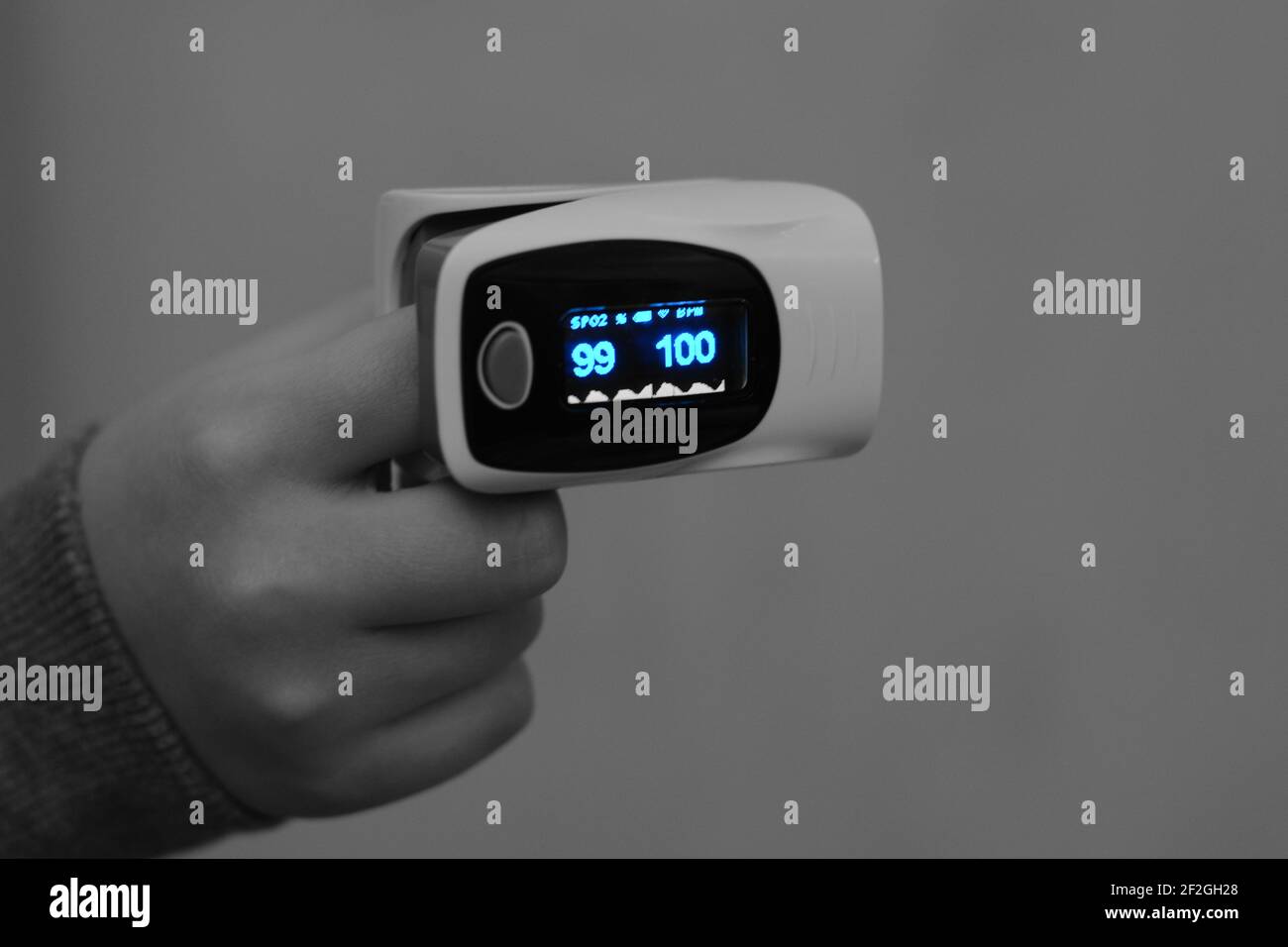 fingertip pulse oximeter equipment connected to the index finger of a ...