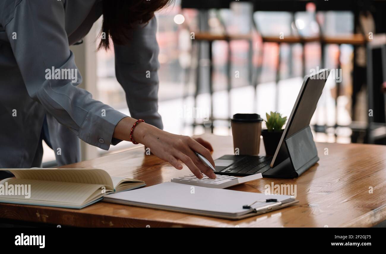 businesswoman working on desk office with using a calculator to ...