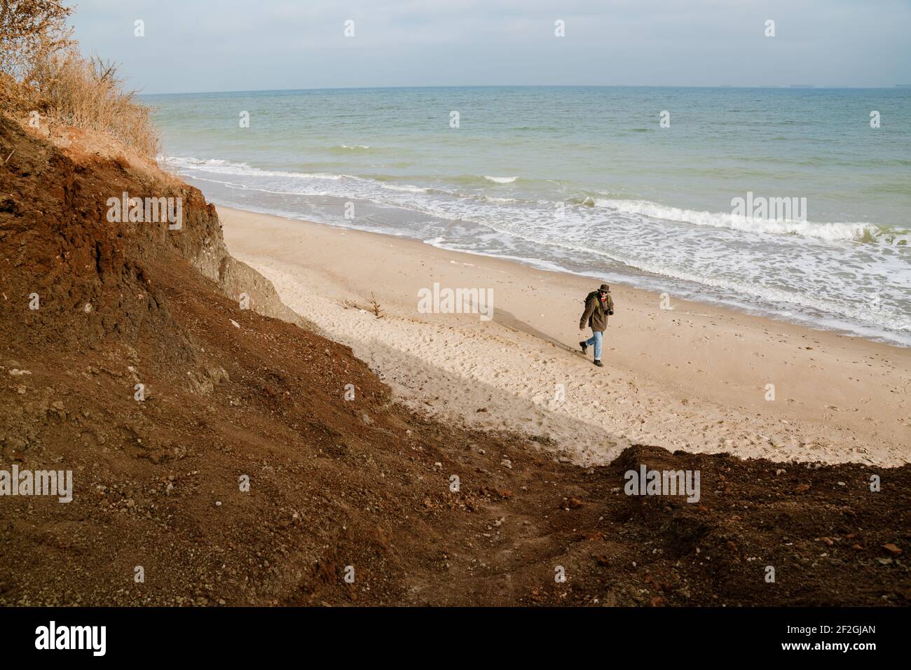 Young photographer walking with digital camera on beach Stock Photo - Alamy