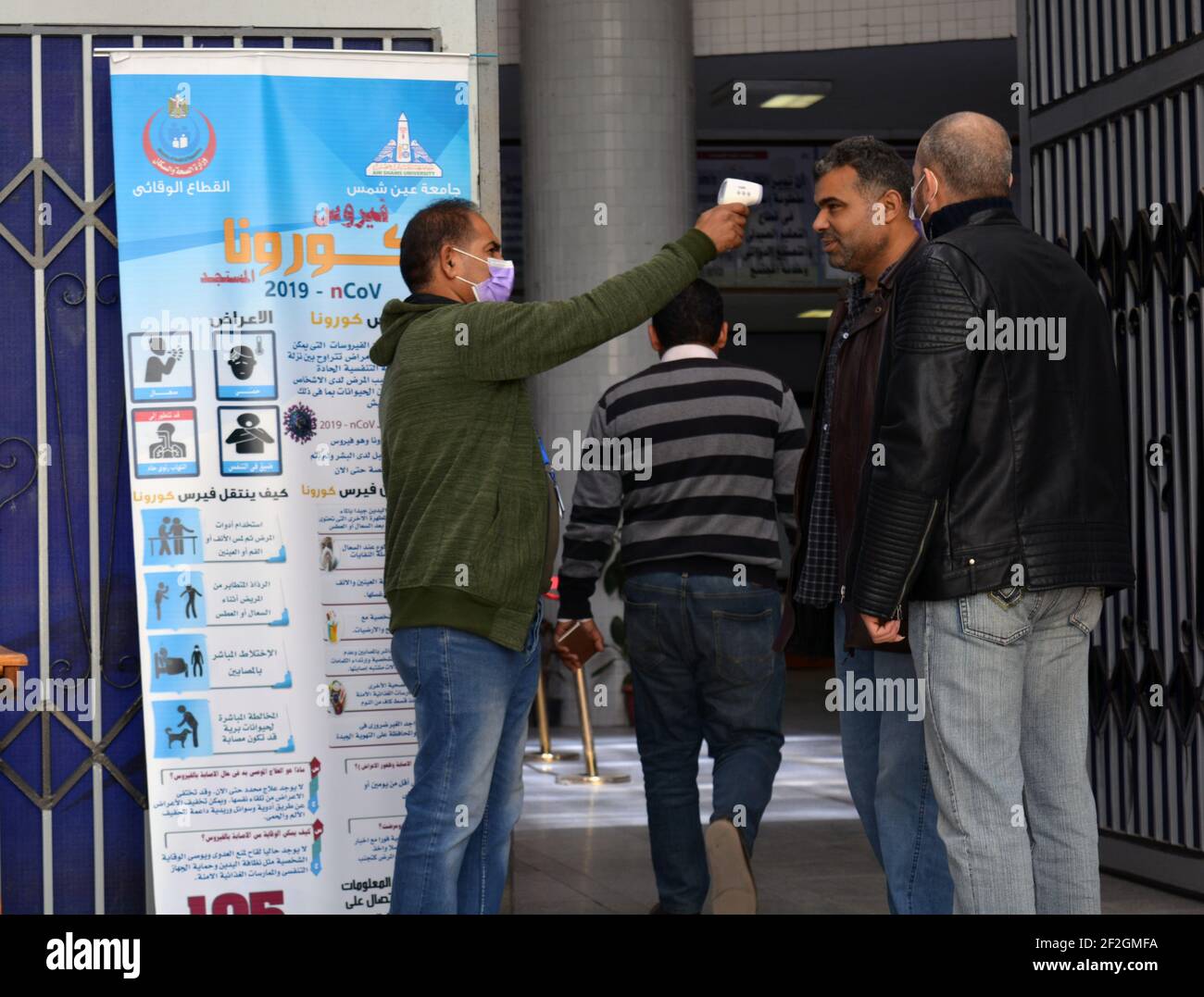 Cairo, Egypt - March 11, 2020. taking person`s temperature with a non ...