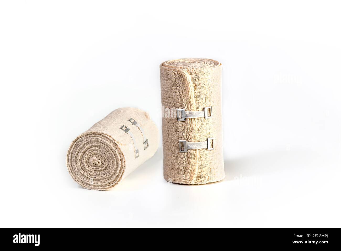 Woven elastic medical bandage rolled into roll and fixation clips ...