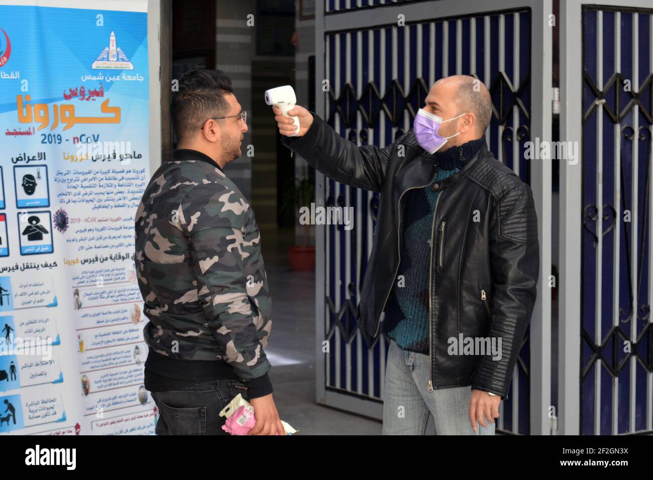 Cairo, Egypt - March 11, 2020. taking person`s temperature with a non ...