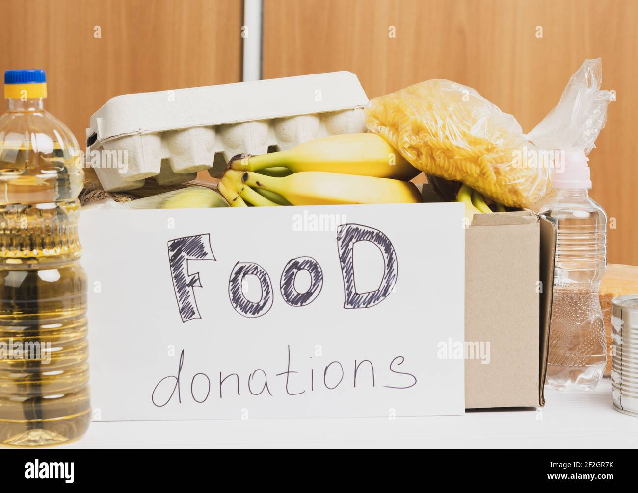 cardboard box with various products, fruits, pasta, sunflower oil in a ...