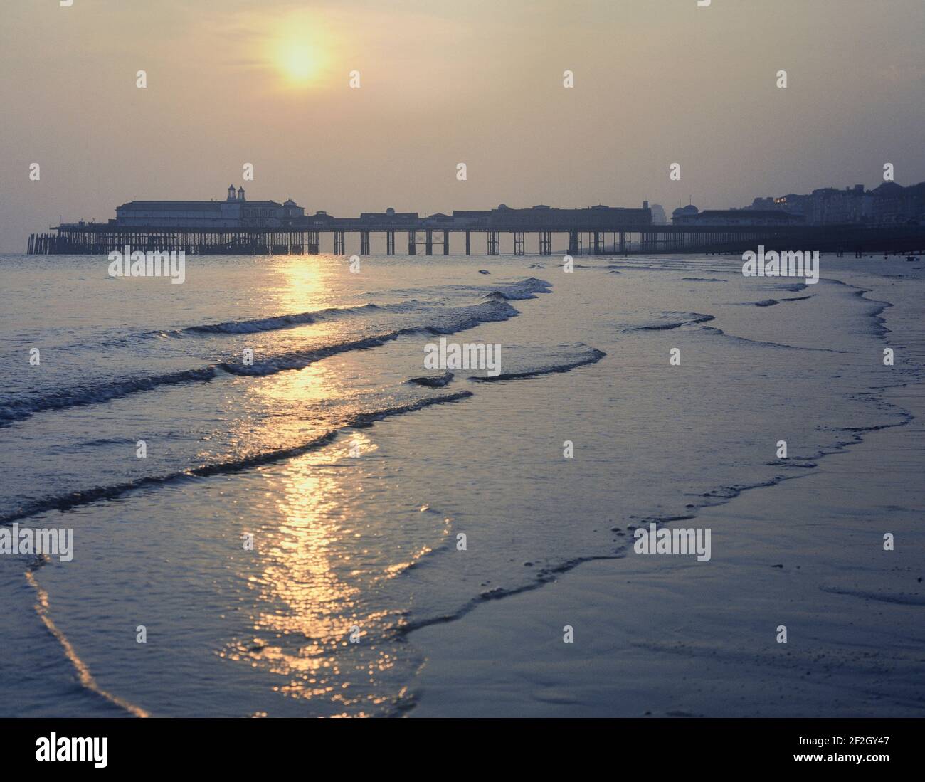 The old Hastings pier at sunset, East Sussex, England, UK. Circa 1990's ...