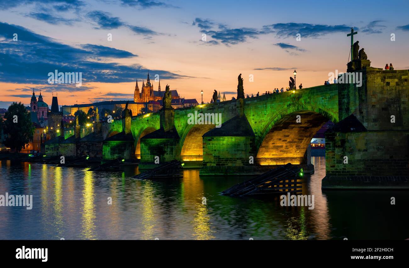 Charles bridge illuminated with green lights at sunset in Prague Stock ...
