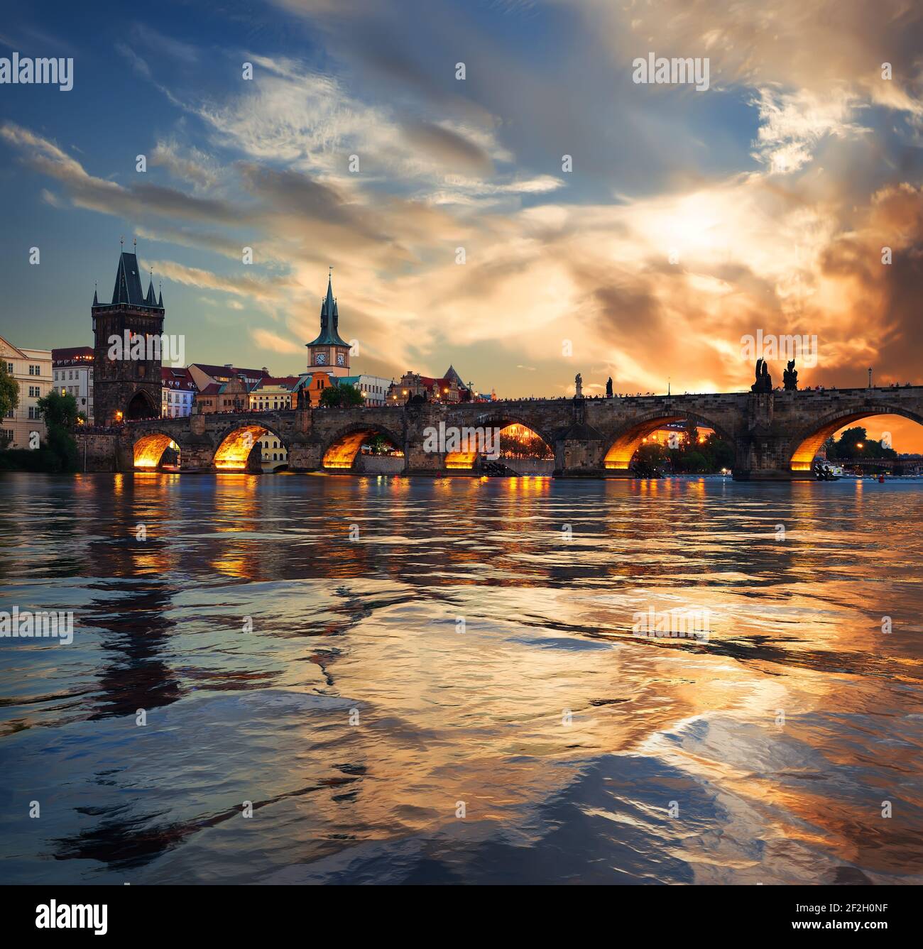 Fiery sunset over Charles bridge on river Vltava in Prague Stock Photo ...