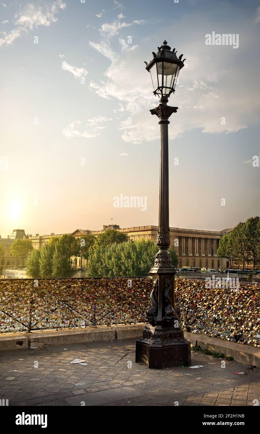 Fence with locks of love around lantern in Paris, France Stock Photo ...