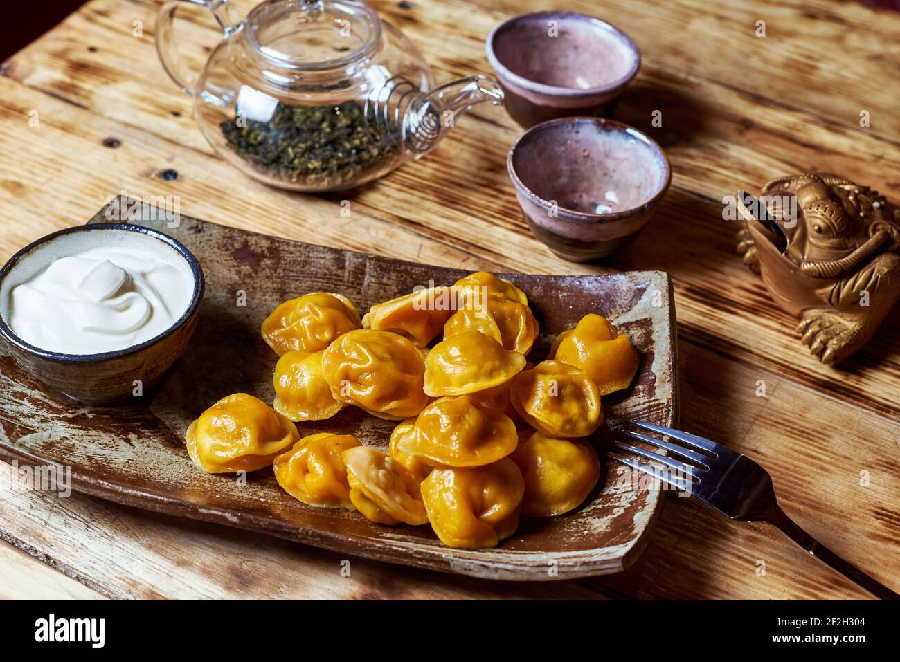Yellow dim sum and tea set on the table in the restaurant Stock Photo ...