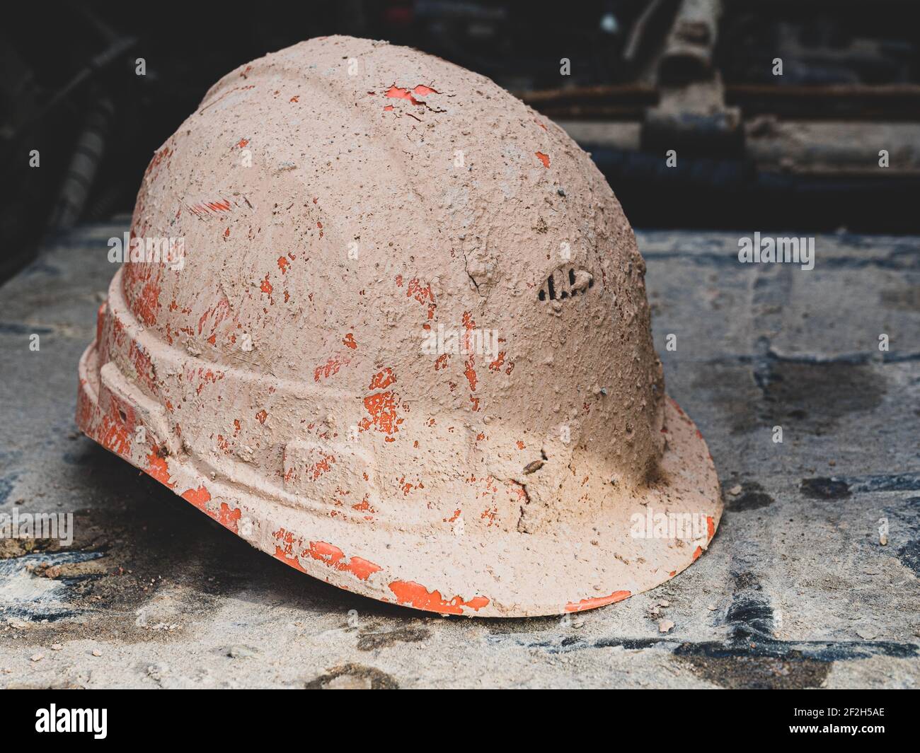 Work Safety Concept. protective construction helmet covered with mud ...