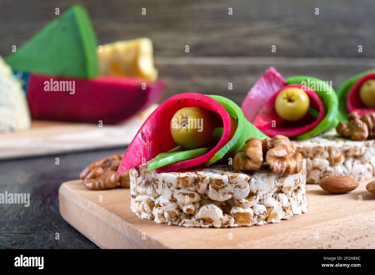 Tasty and healthy canapes with craft cheese, olives, nuts and whole ...