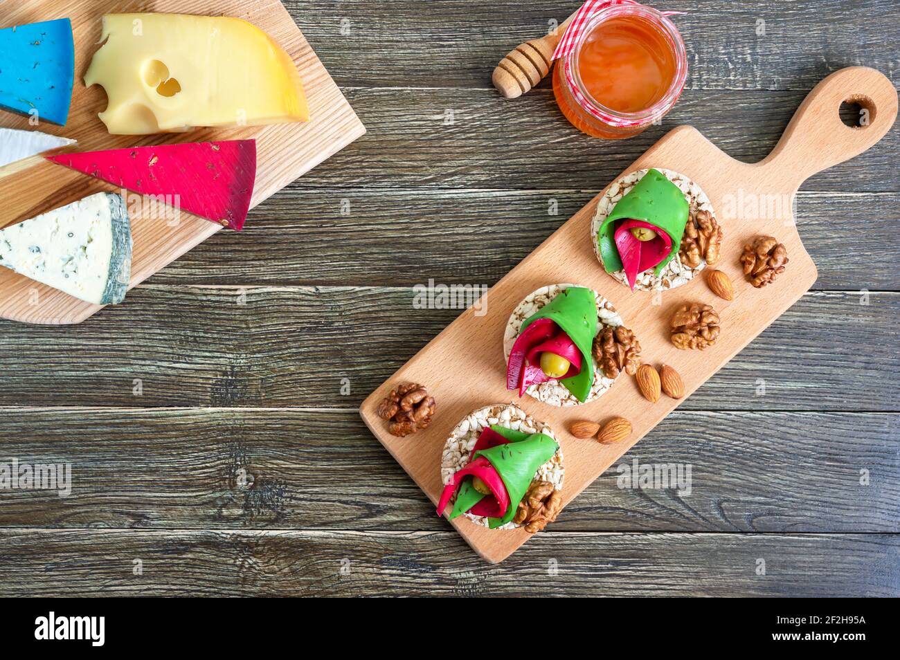 Tasty and healthy canapes with craft cheese, olives, nuts and whole ...