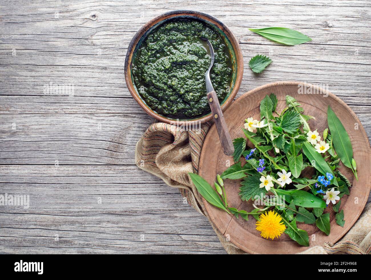 Healthy soup with fresh spring ingredients. Dandelion, wild garlic ...
