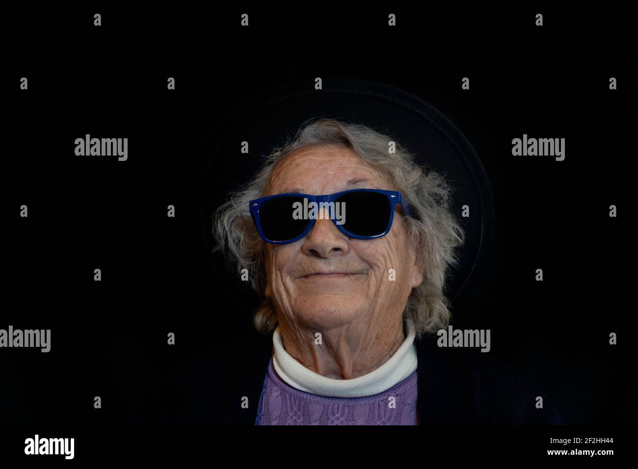 Senior elderly 80s woman with sunglasses on dark background.Portrait ...