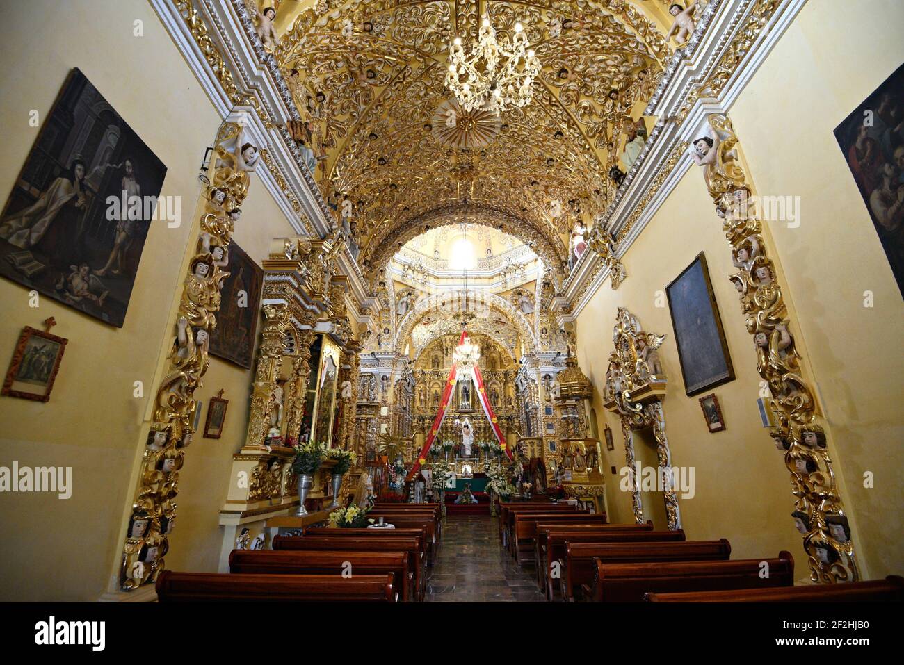 Interior view with a pure gold dressed altar of the Mexican-Baroque ...