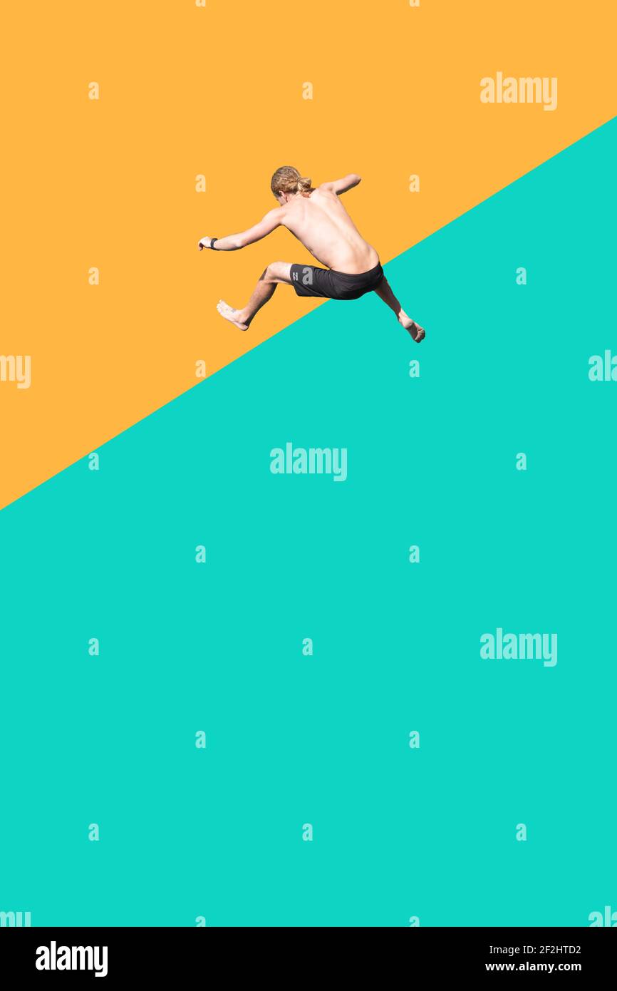 Man jumping from green to yellow part [M] Stock Photo - Alamy