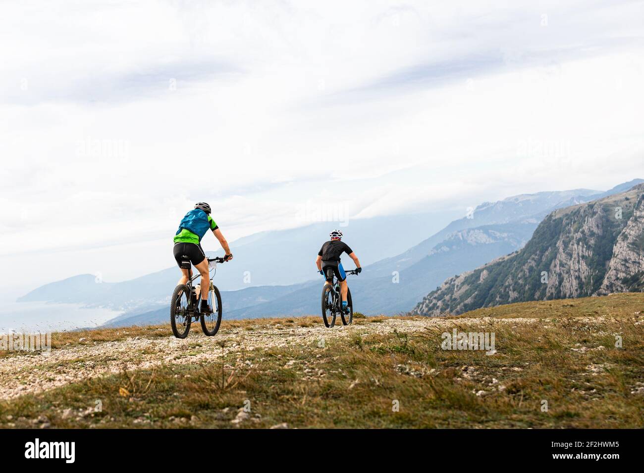 Two cyclists riding on road hi-res stock photography and images - Alamy