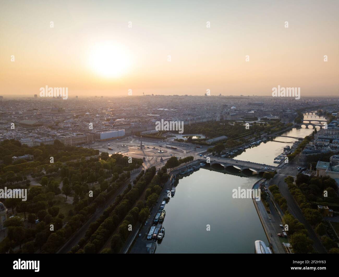Aerial view above the Seine river, facing the morning rising sun, and ...