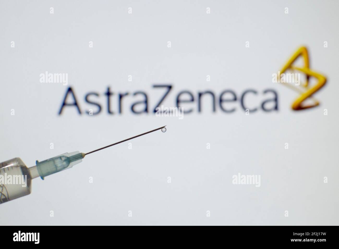 Photograph of a medical syringe with a drop coming out of the needle ...