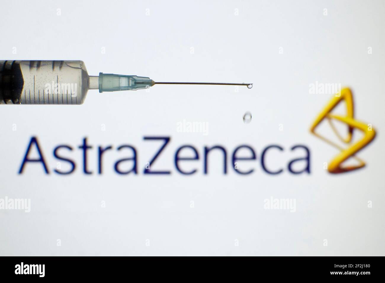 Photograph of a medical syringe with a drop coming out of the needle ...