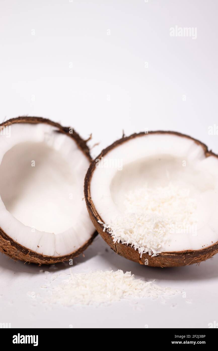 opened coconut with coconut flakes isolated on white background ...